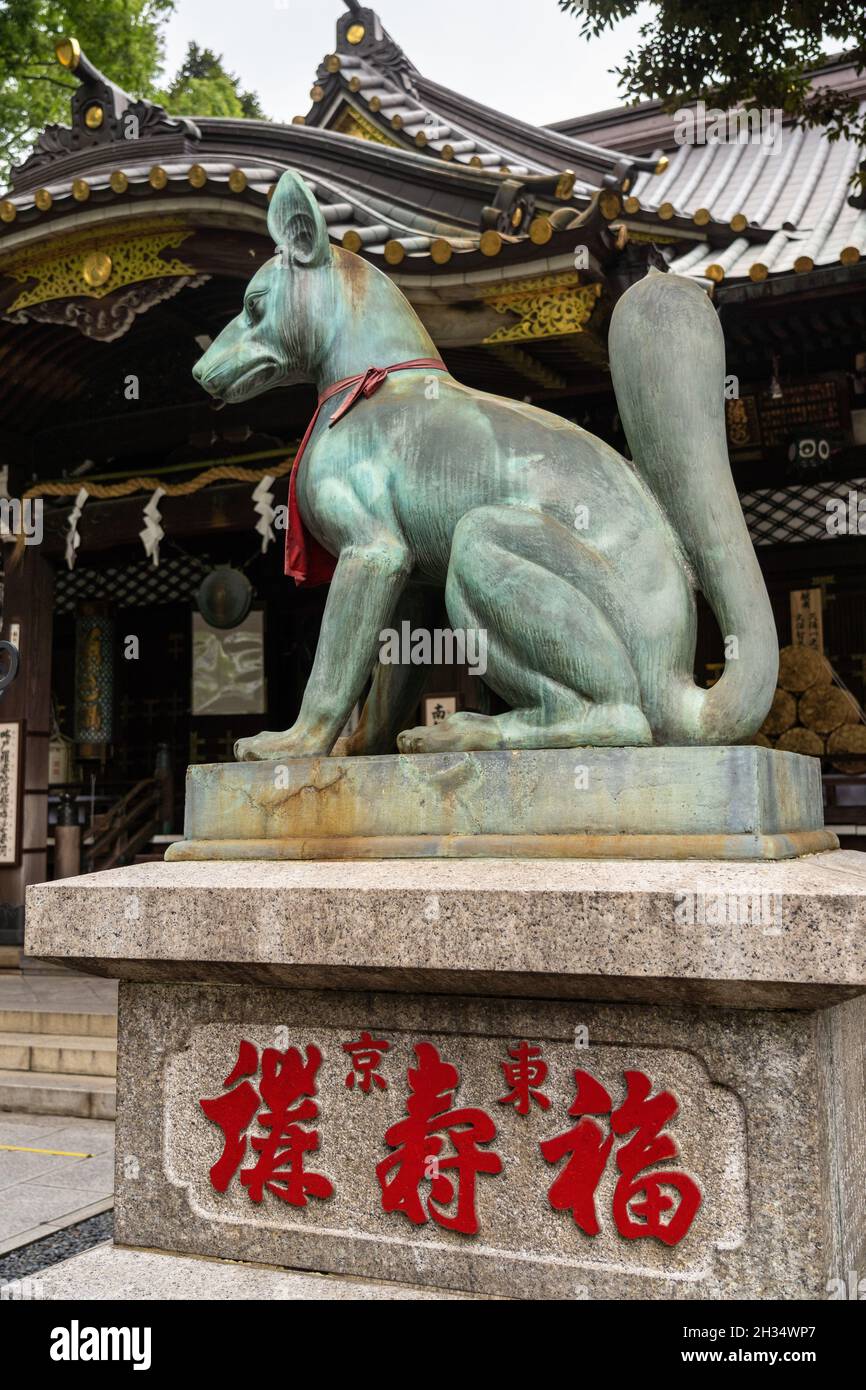 A massive bronze statue of Inari Kitsune or fox goddess, guard the ...
