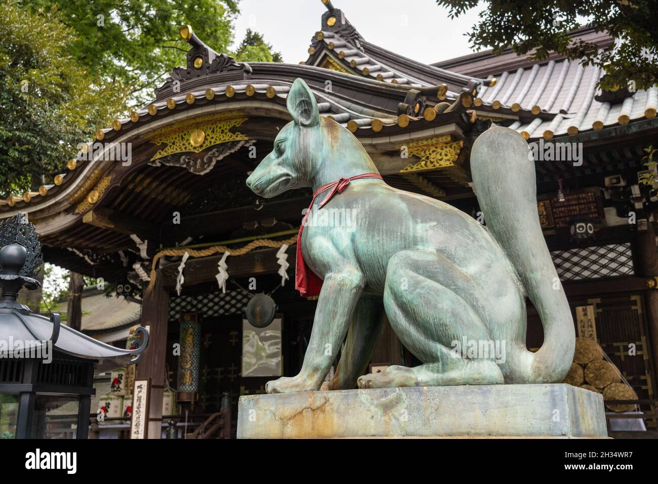 A massive bronze statue of Inari Kitsune or fox goddess, guard the ...