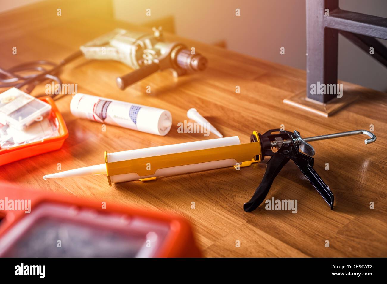 closeup white silicone caulk cartridge and sealant gun Stock Photo - Alamy
