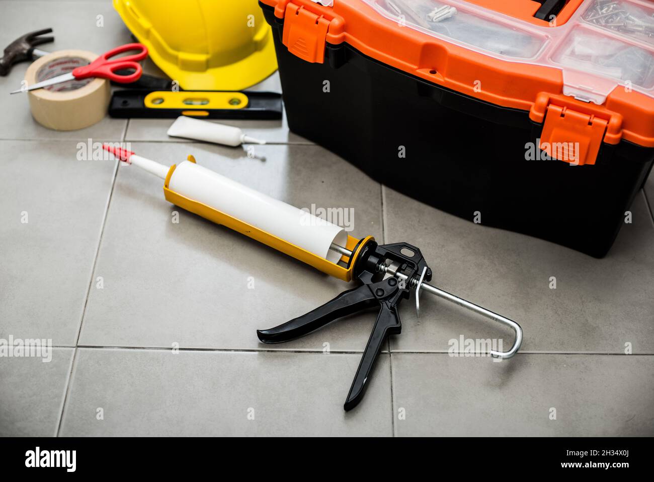 closeup white silicone caulk cartridge and sealant gun Stock Photo - Alamy