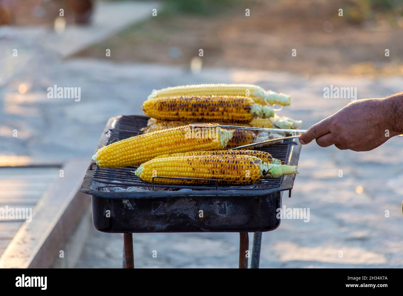 Man selling grilled corn on hi-res stock photography and images - Alamy