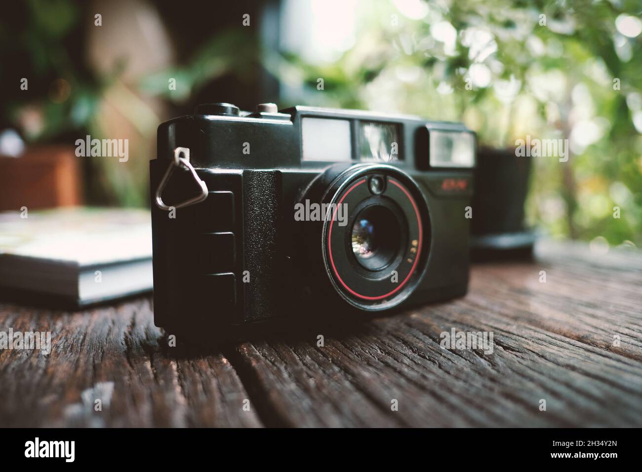 old black film camera on wooden desk. vintage camera decorated in the ...