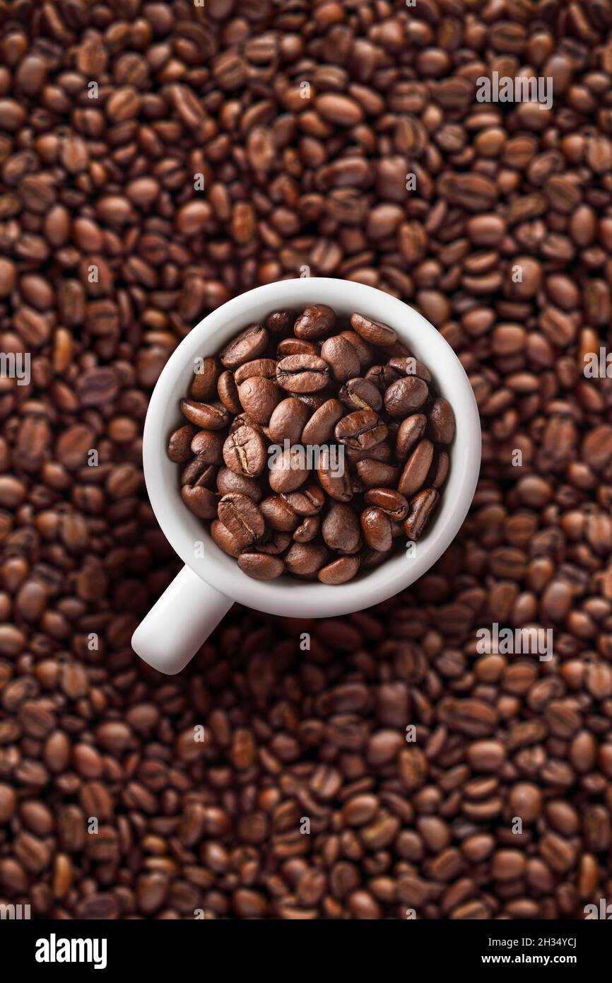 Coffee cup on beans background Stock Photo - Alamy
