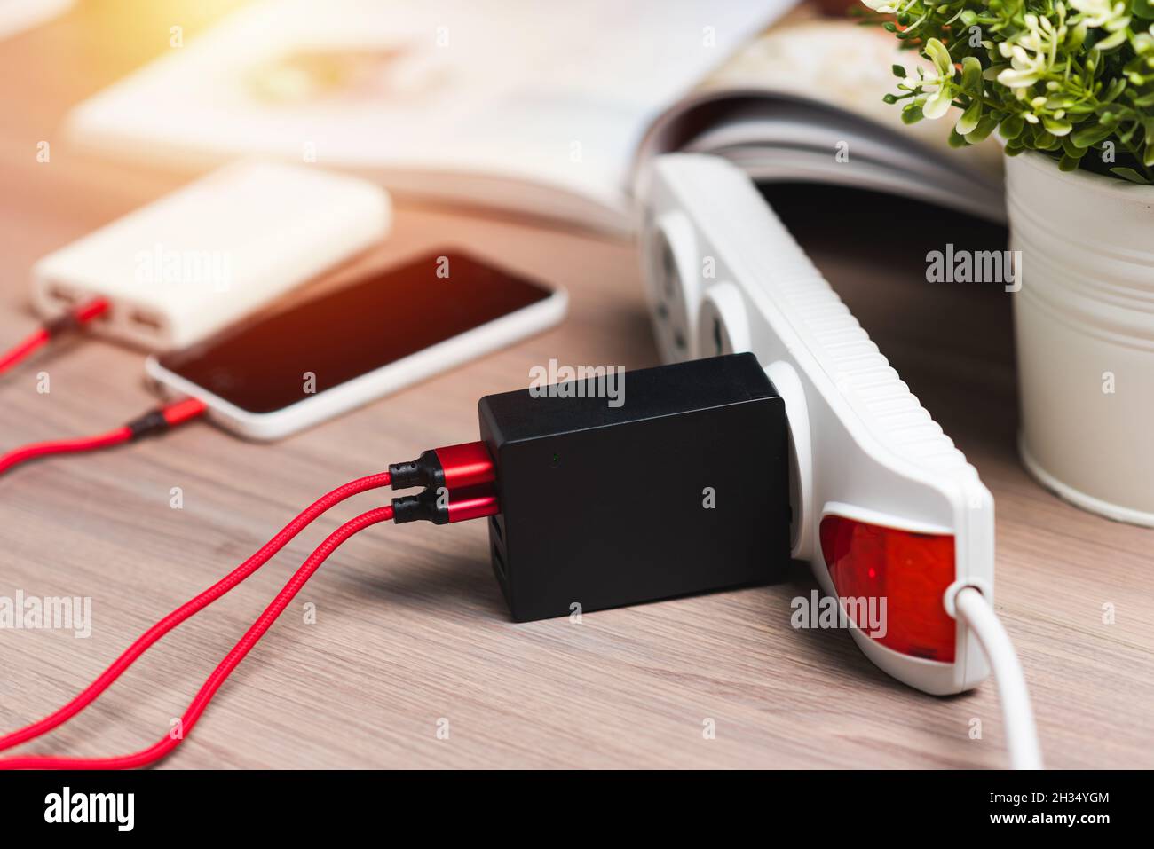 Closeup black charger with 4 usb port output. Charging electronic ...