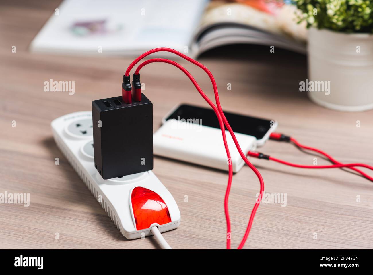 Closeup black charger with 4 usb port output. Charging electronic ...