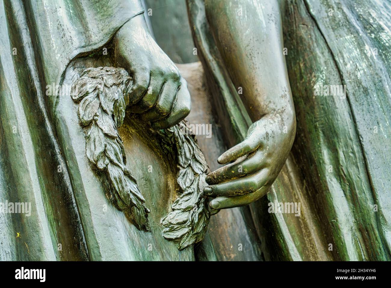 A laurel wreath is symbolically passed by “Defeated Victory” statues on ...