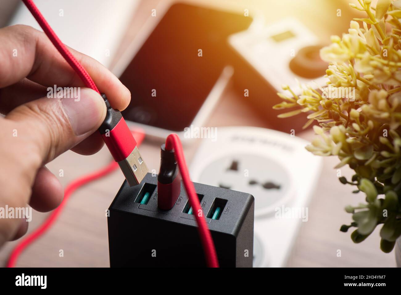 Closeup black charger with 4 usb port output. Charging electronic ...