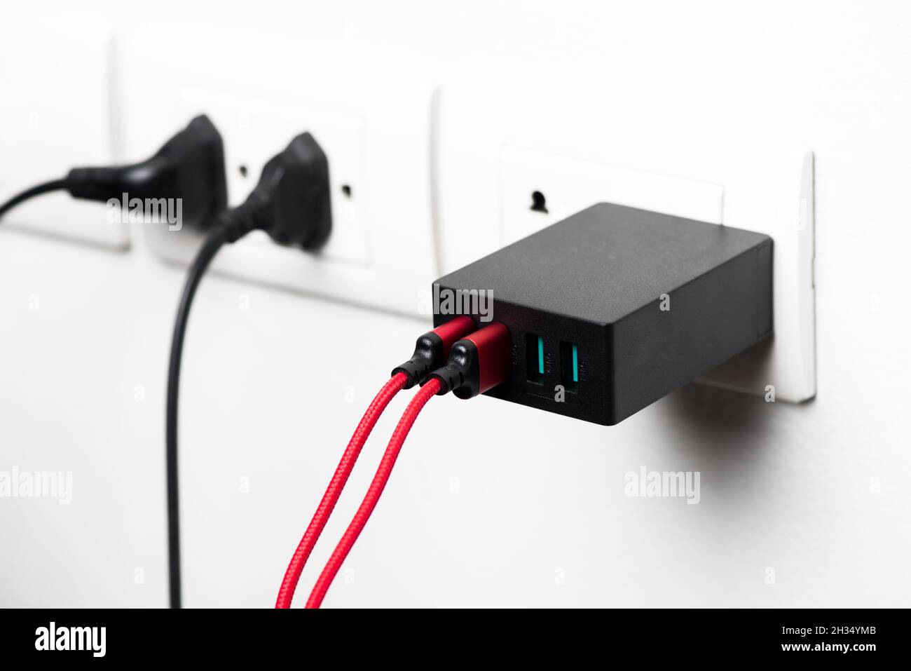 Closeup black charger with 4 usb port output. Charging electronic ...