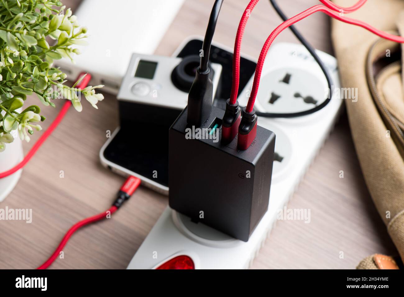 Closeup black charger with 4 usb port output. Charging electronic ...