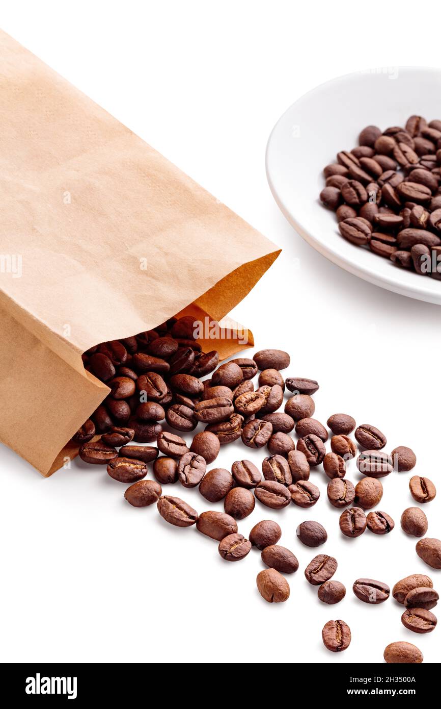 Paper bag with coffee beans and saucer Stock Photo - Alamy