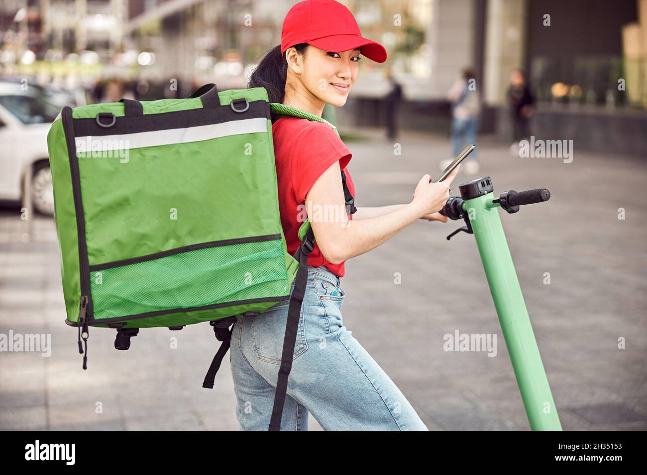 Delivery woman with backpack delivering takeaway food to customer ...