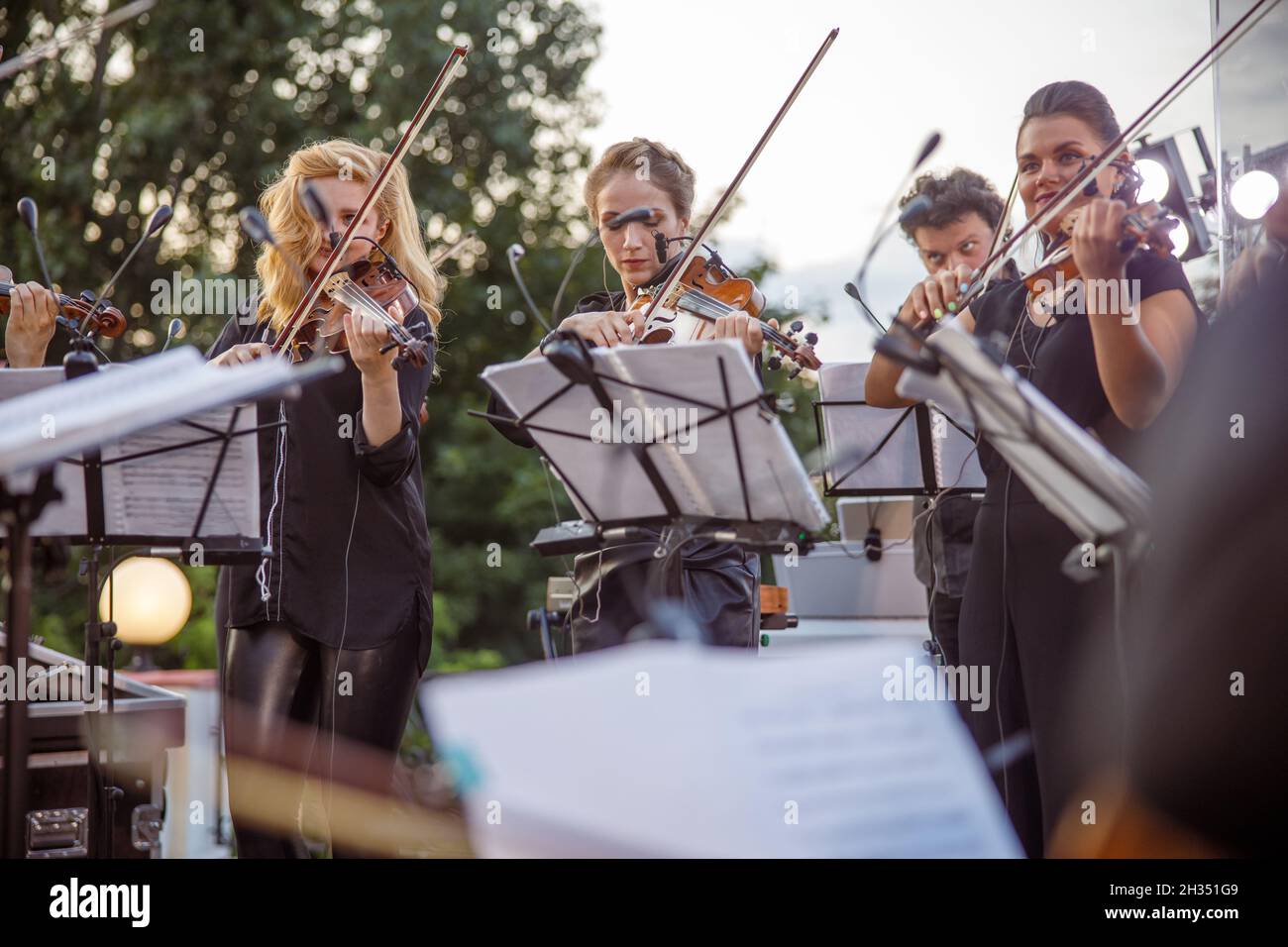 Violin players giving live orchestral concert on the street Stock Photo ...