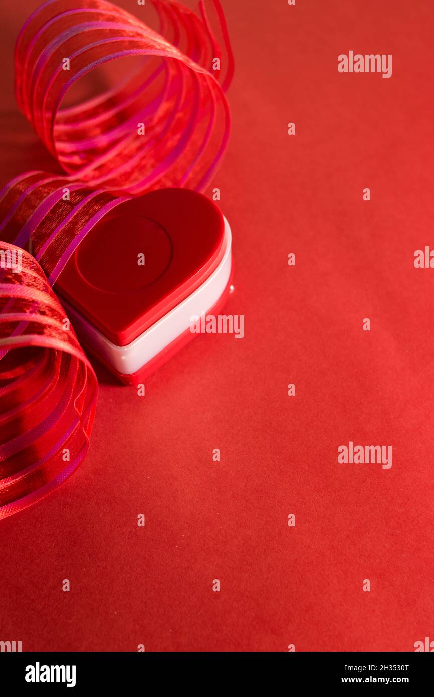 Red heart shaped chest with red ribbon on a red background Stock Photo ...