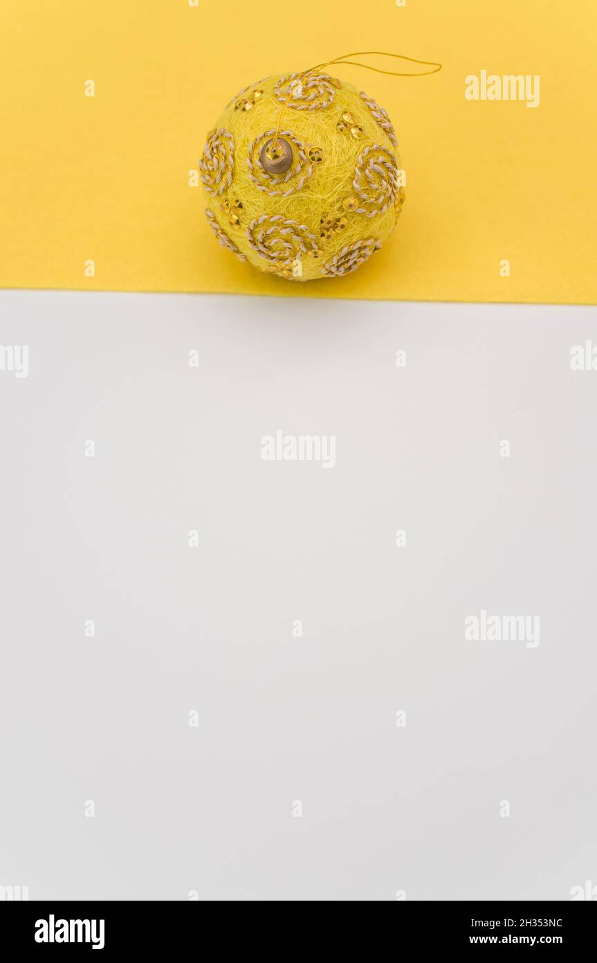 Christmas time paper decoration balls on a white yellow background ...
