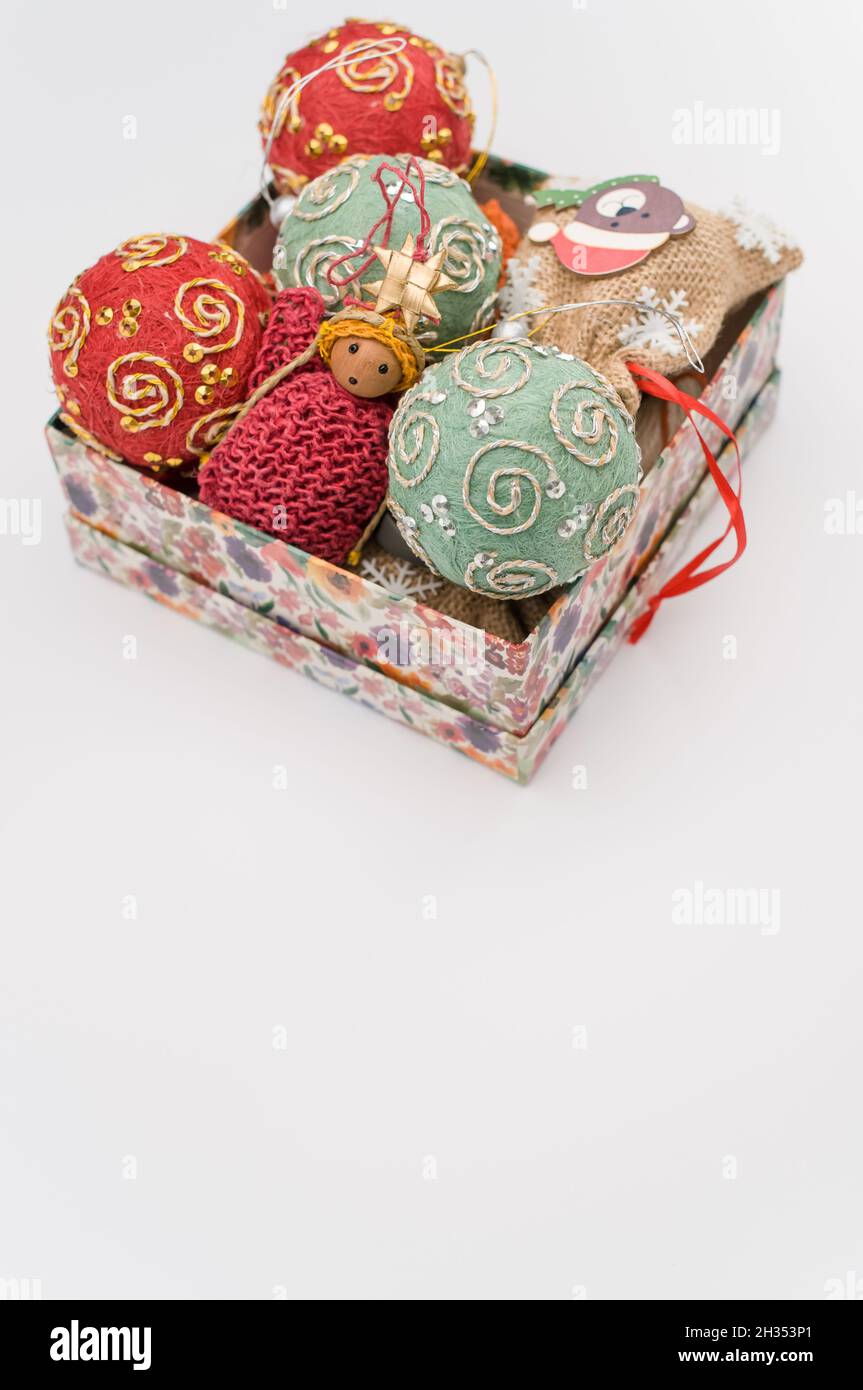 Christmas time decorations in a paperboard box on white background ...