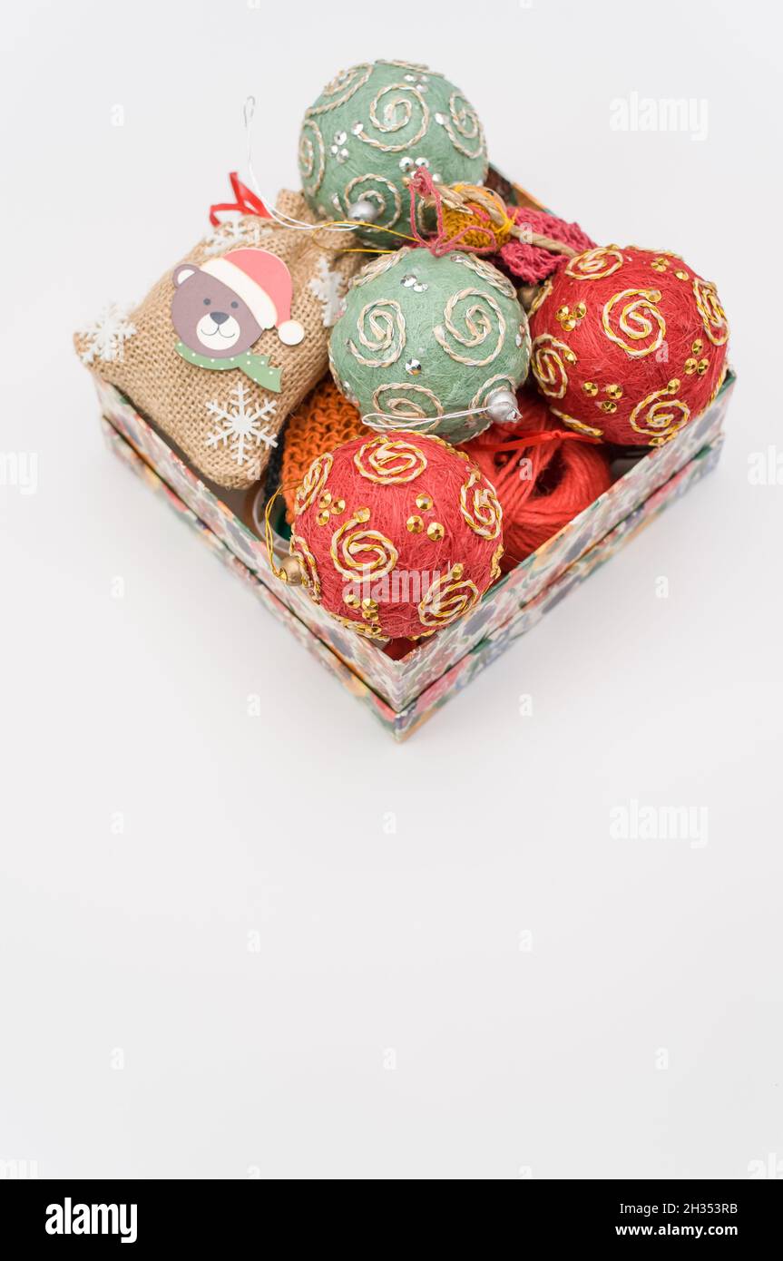 Christmas time decorations in a paperboard box on white background ...
