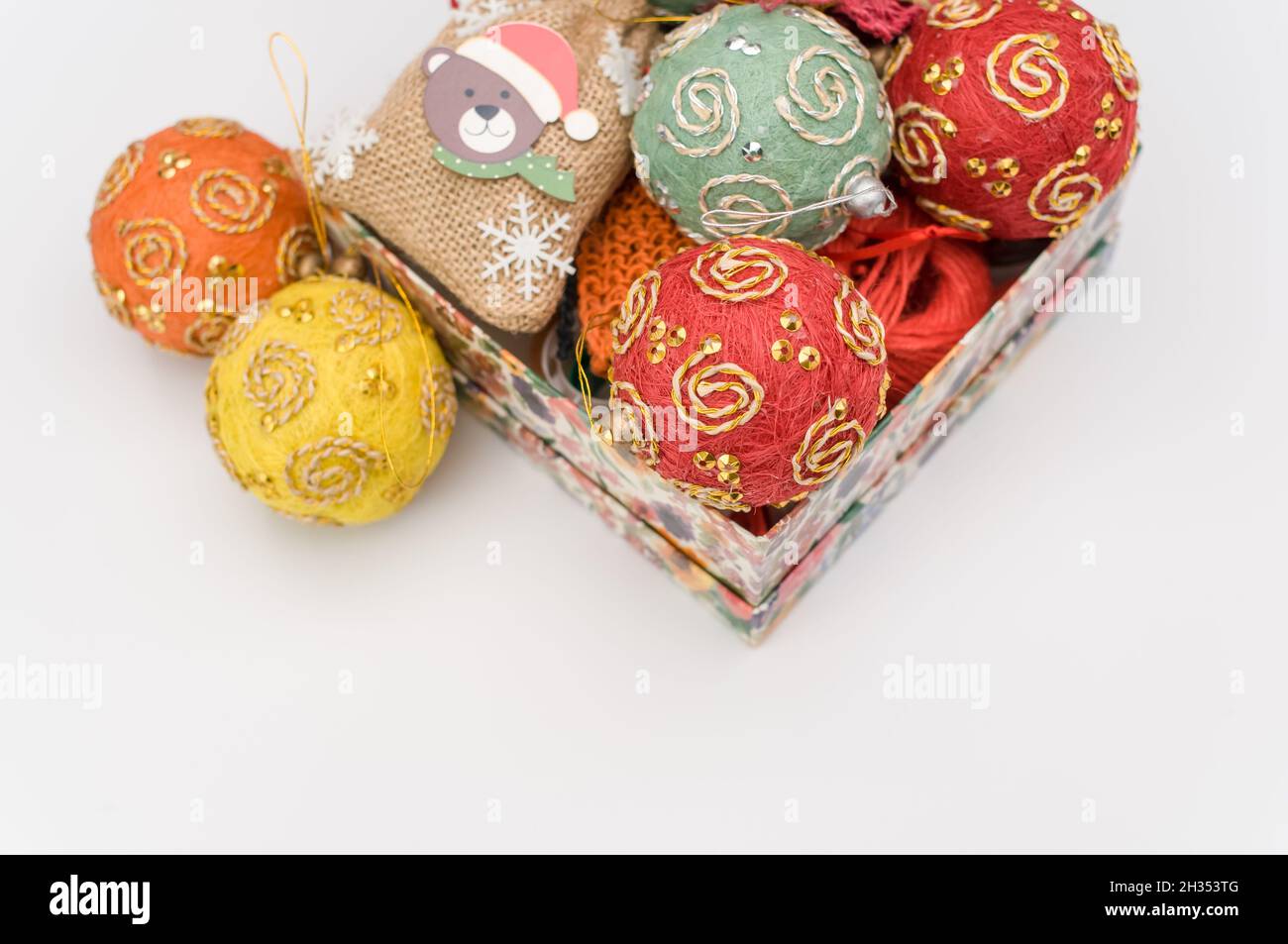 Christmas time decorations in a paperboard box on white background ...