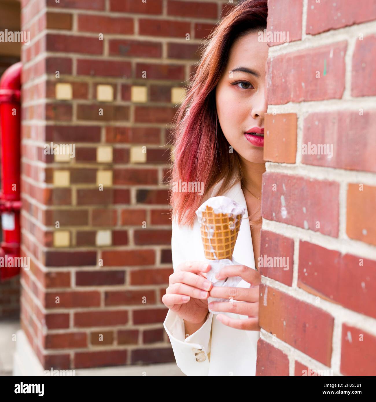Woman eating ice cream cone hi-res stock photography and images - Alamy
