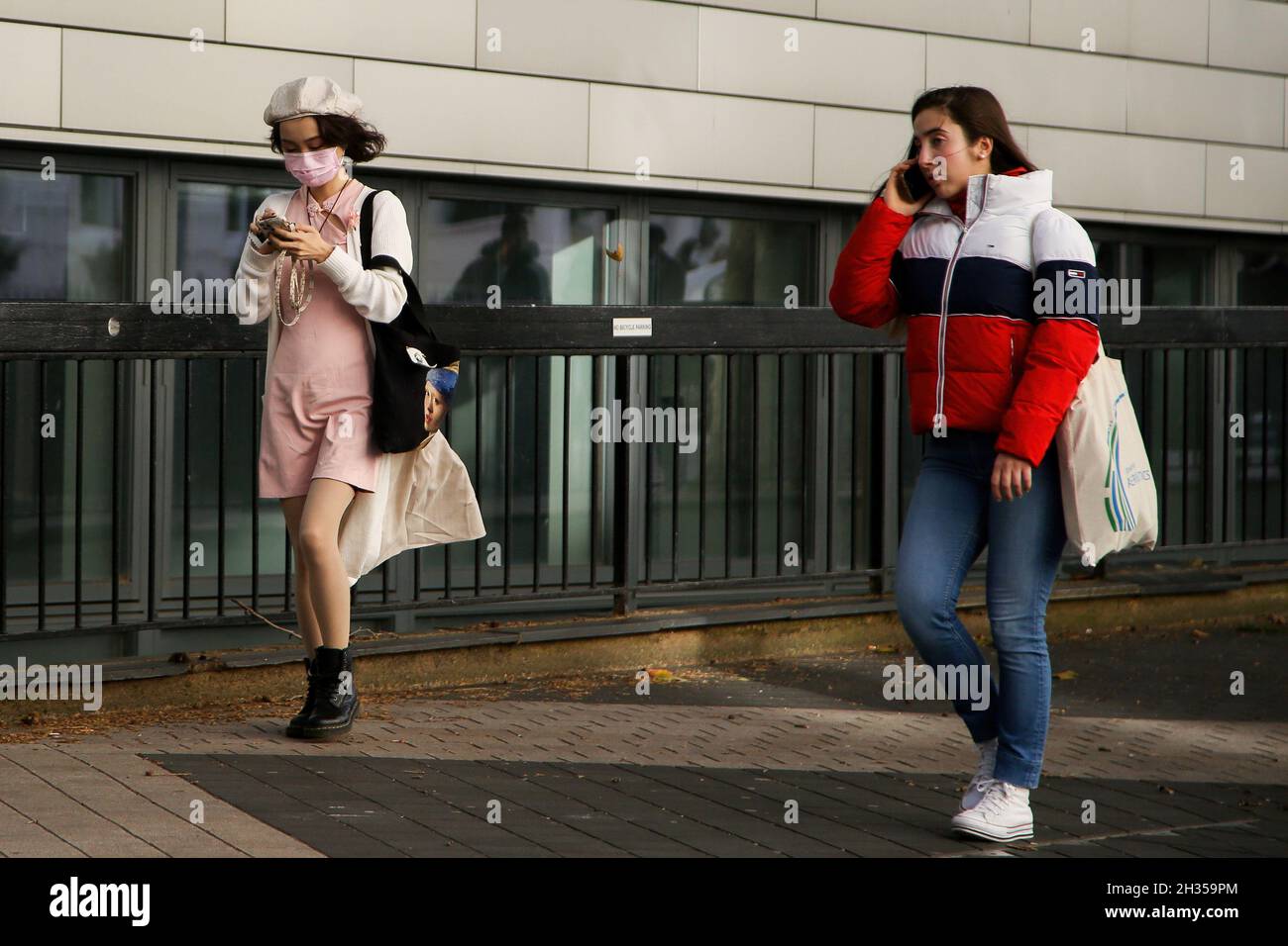 Women seen using their mobile phones while walking Stock Photo - Alamy