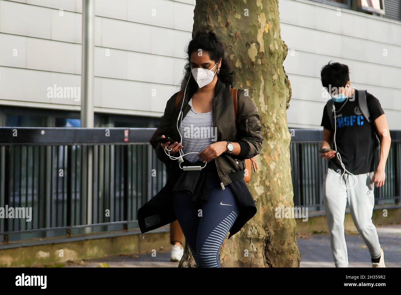 People seen using their mobile phones while walking Stock Photo - Alamy