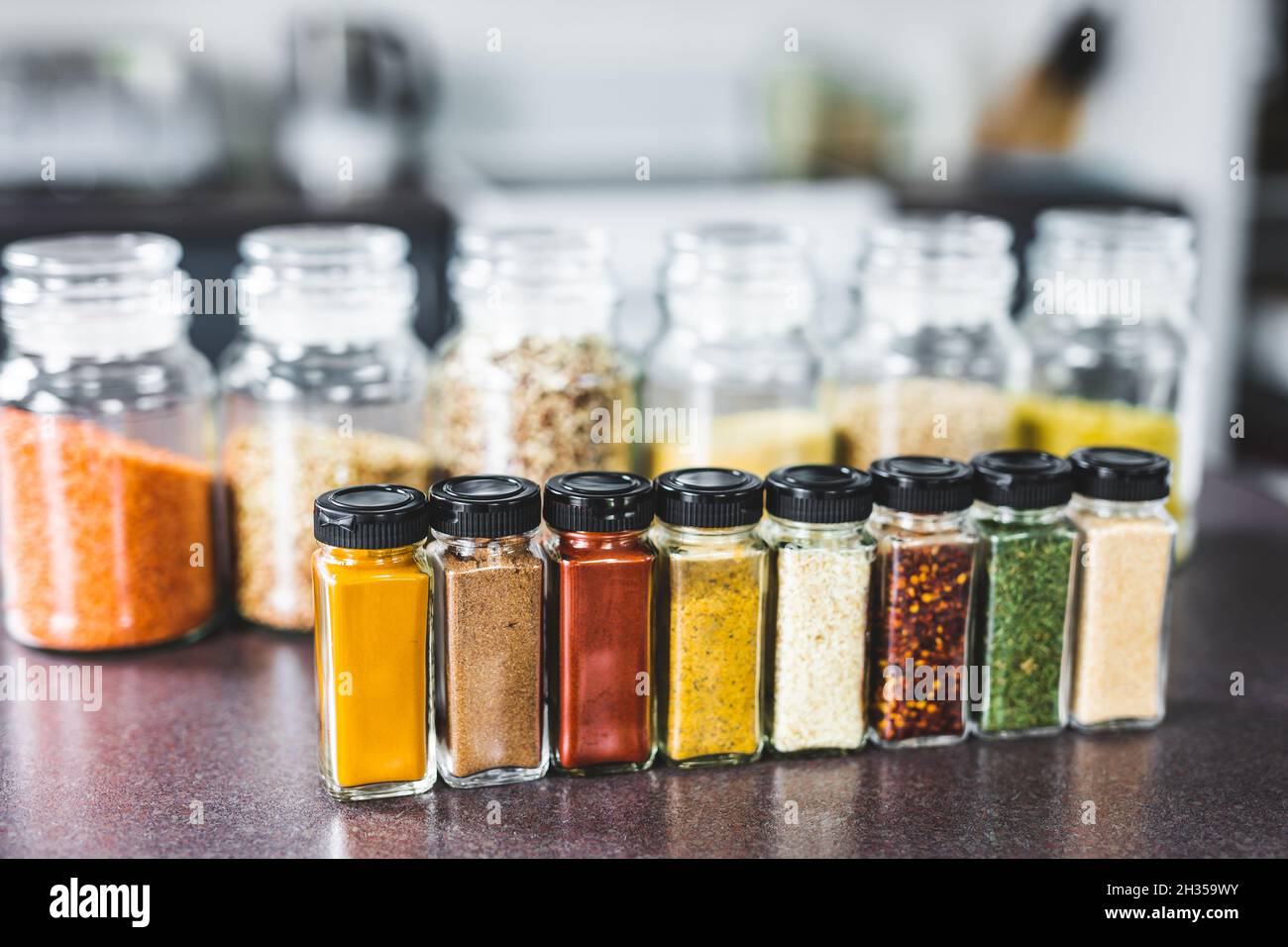 spices and grains in matching spice jars on kitchen counter, simple ...