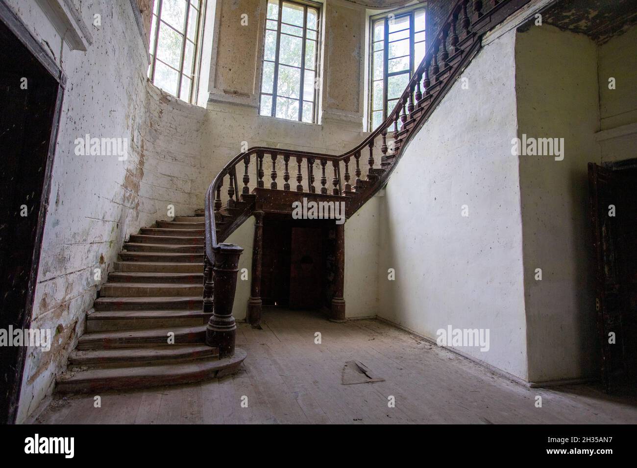 Bottom view of the wooden staircase in an old castle in light colors ...
