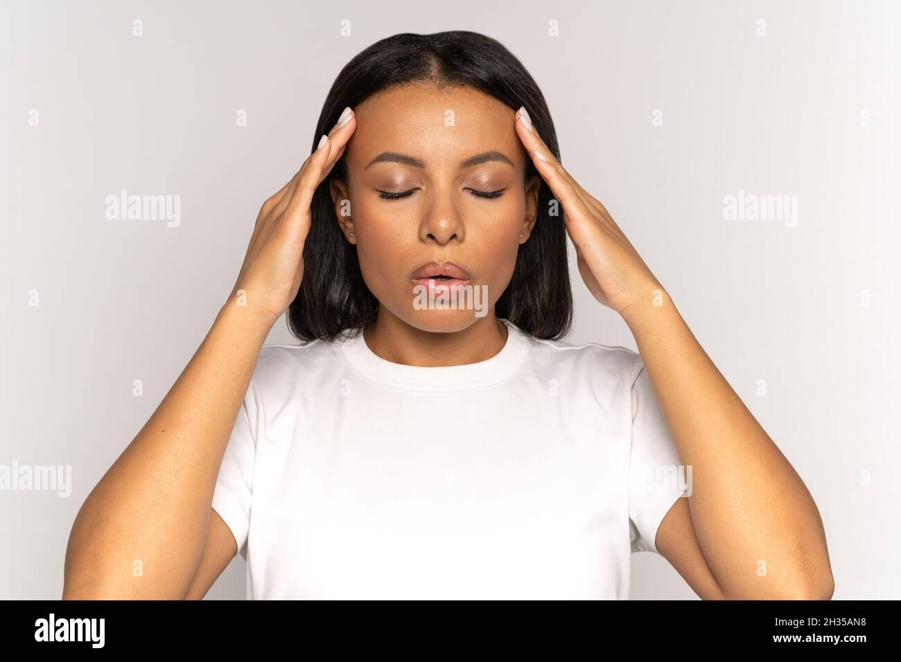 Stressed african woman massage temples breath in deeply to relief from ...