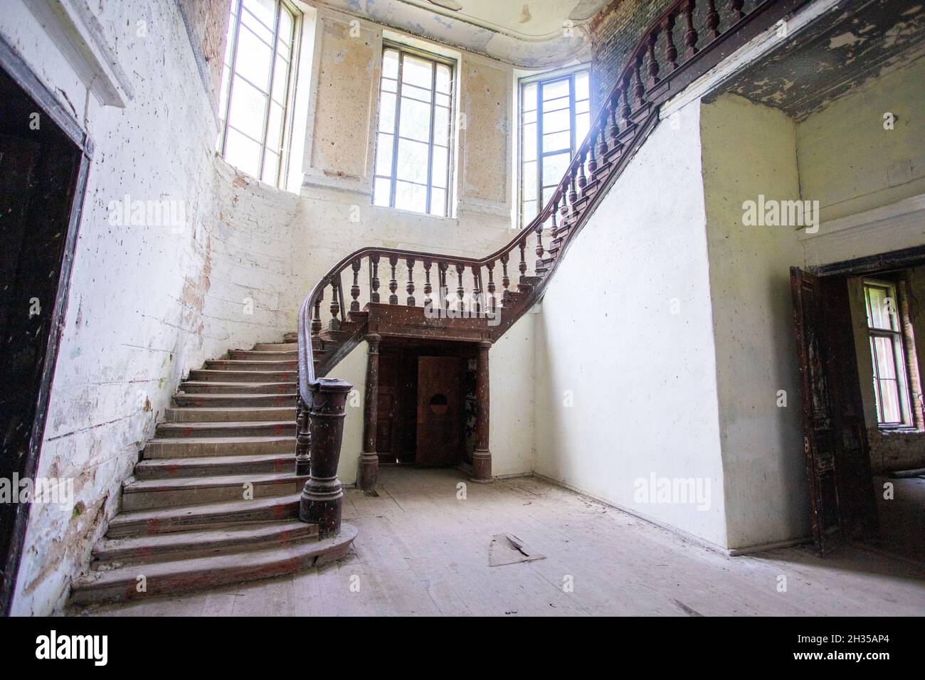 Bottom view of the wooden staircase in an old castle in light colors ...