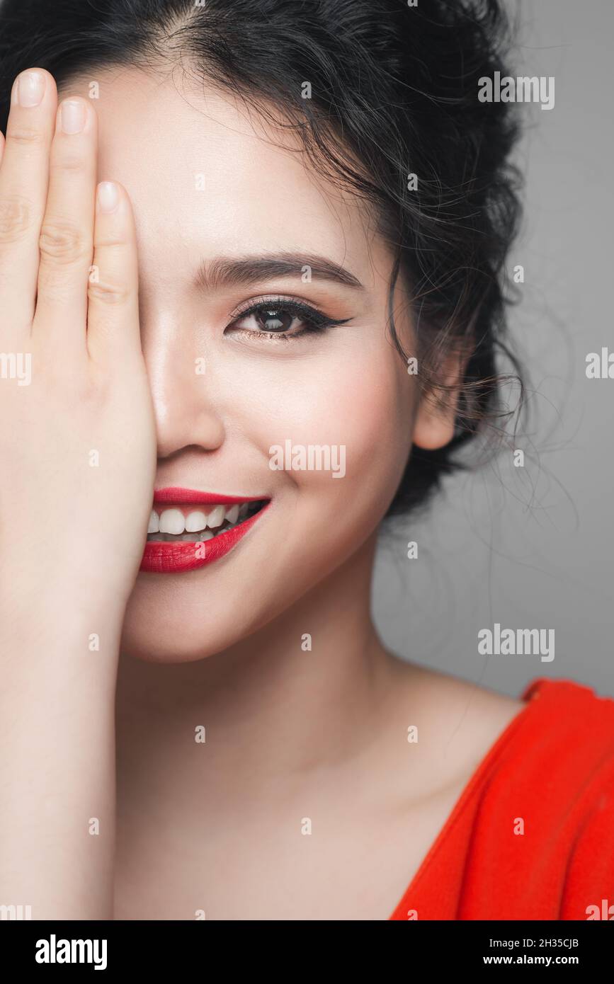 Young woman covering half of her face with a palm of her hand Stock ...