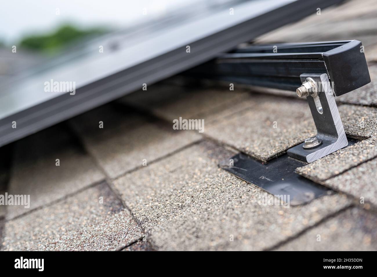 Rail, bracket, and anchor to a solar panel installed on a asphalt ...