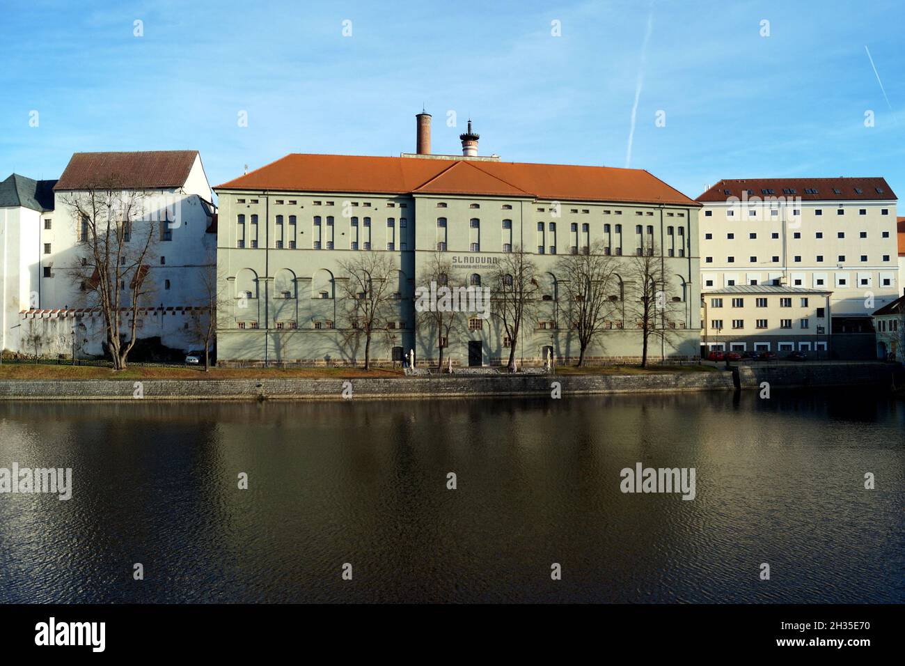 Waterfront buildings of the old sugar factory over the Otava River ...