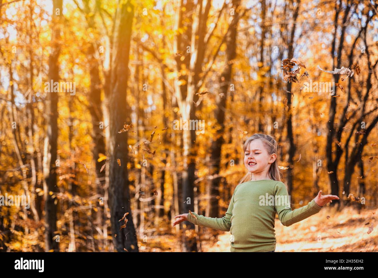 Small happy smiling little caucasian child girl playing with yellow ...