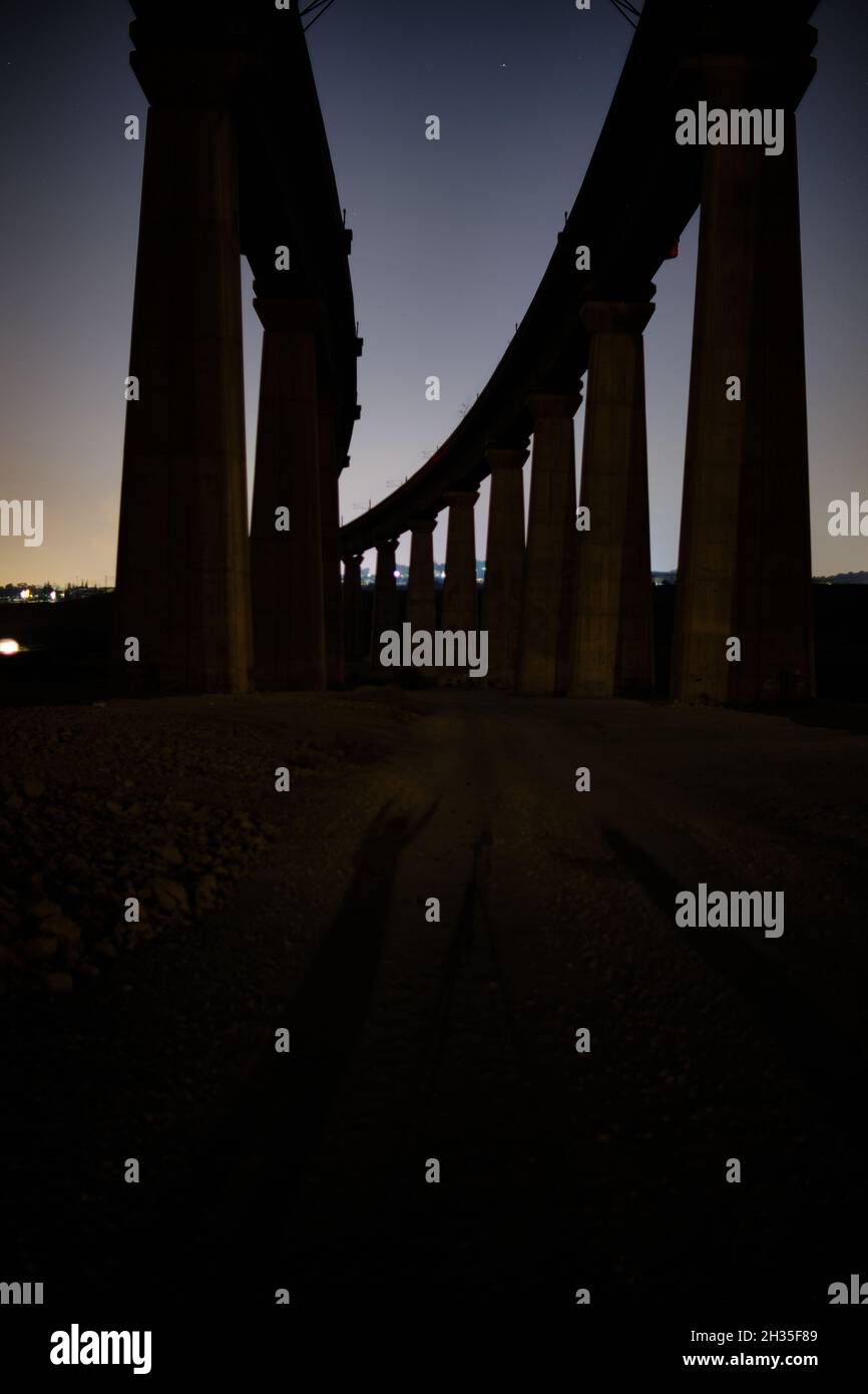 View of an Architectural structure with rocky columns at night with ...