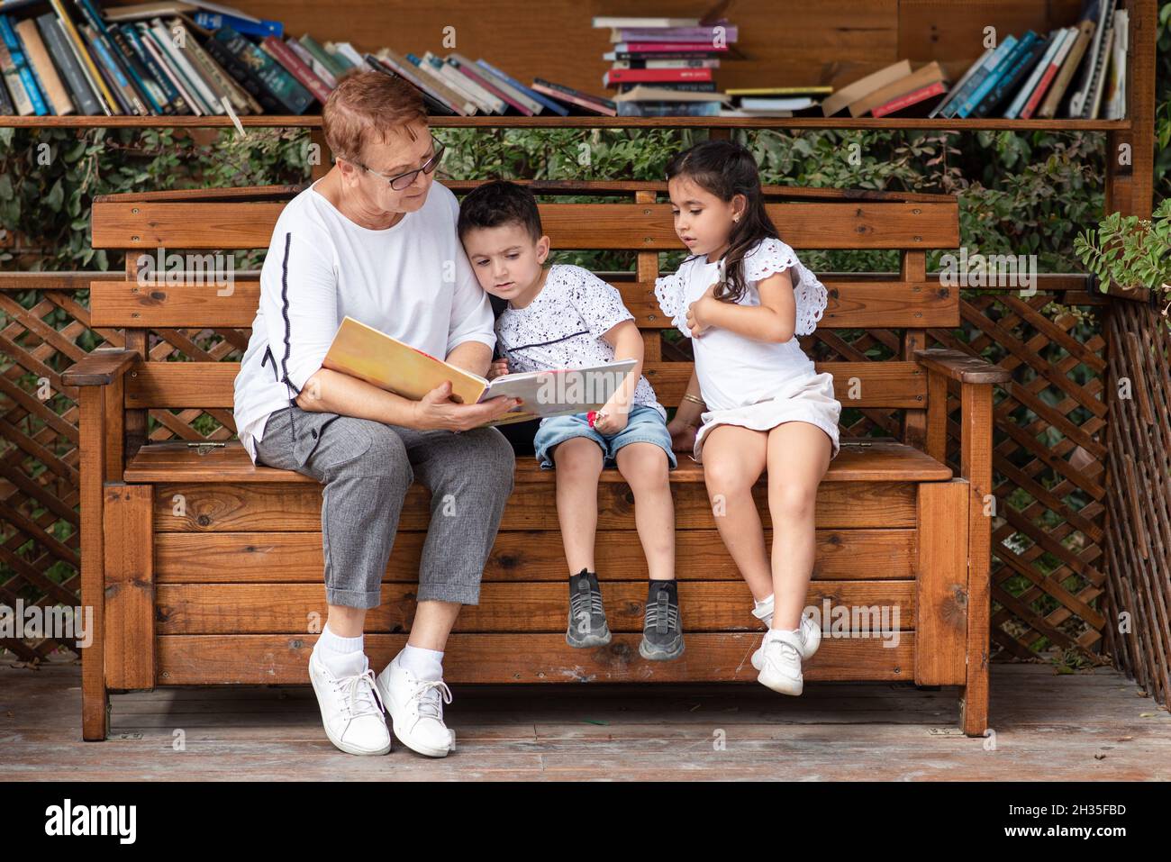 Grandmother reading book grandchildren hi-res stock photography and ...