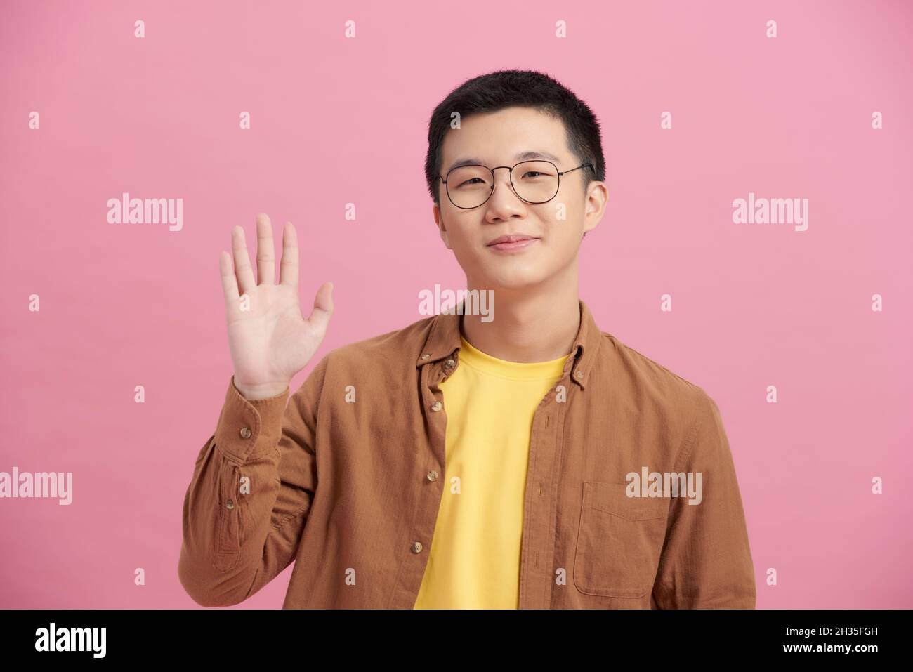 Asian man raising hand in hi-res stock photography and images - Alamy