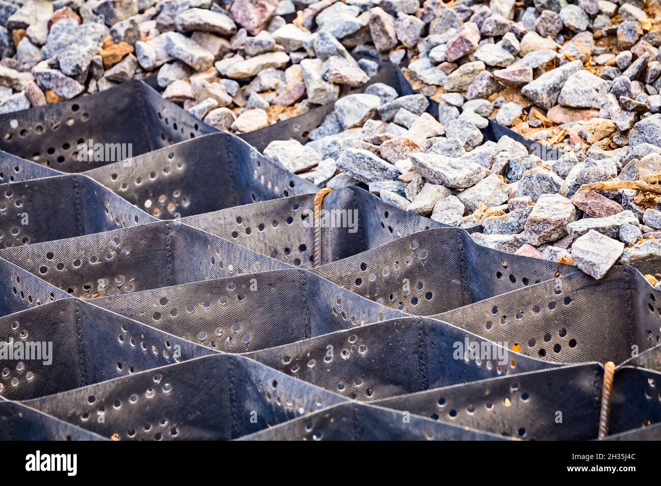 Cellular confinement system - plastic black honeycomb frame filled with ...