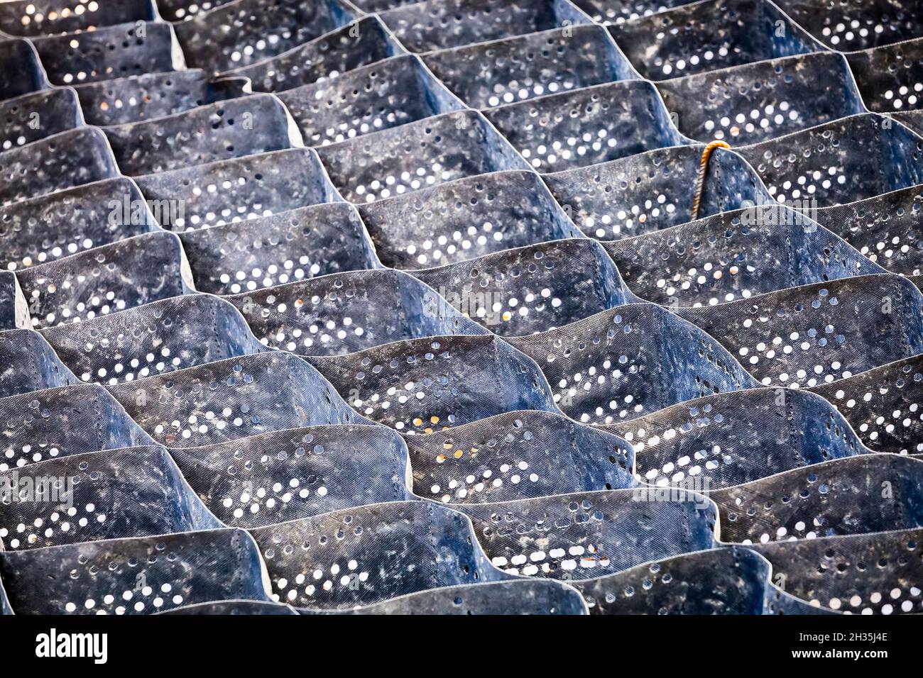 Cellular confinement system - plastic black honeycomb frame filled with ...