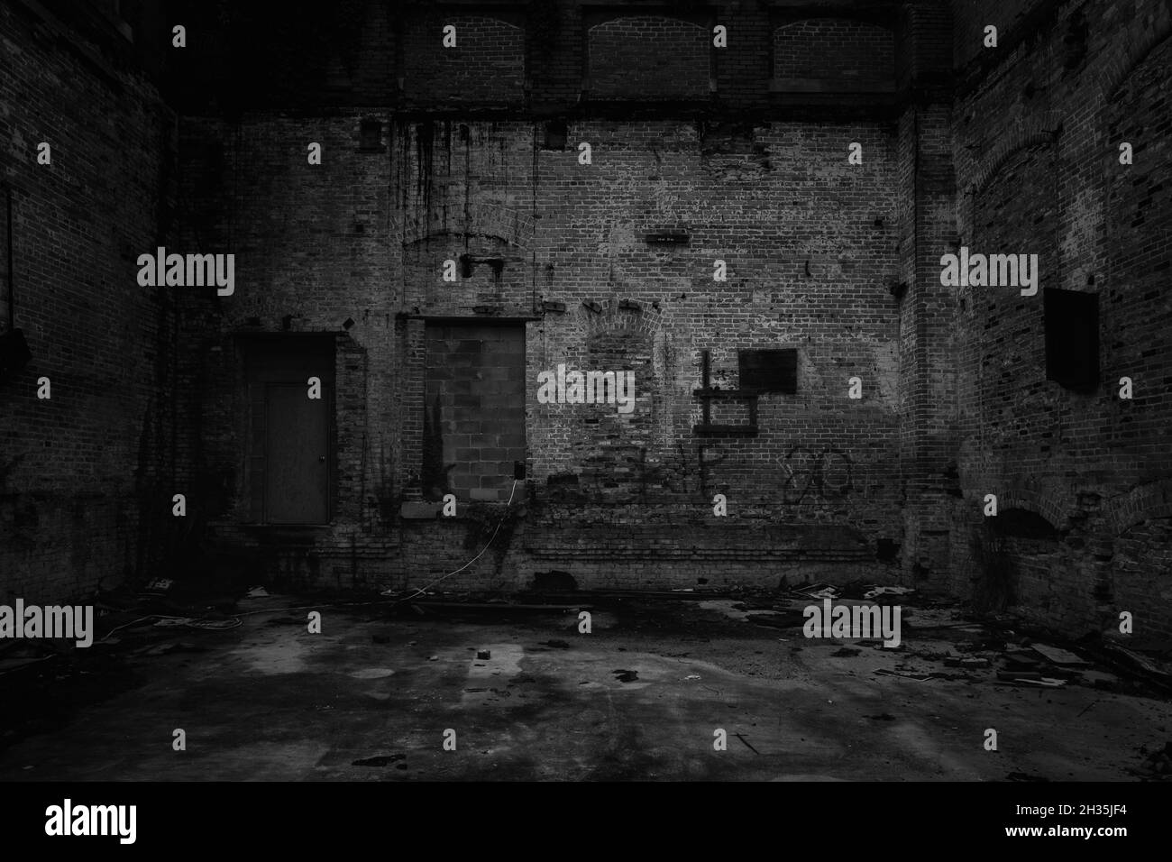 Grayscale view of an old rusty black wall with little shadows with an ...