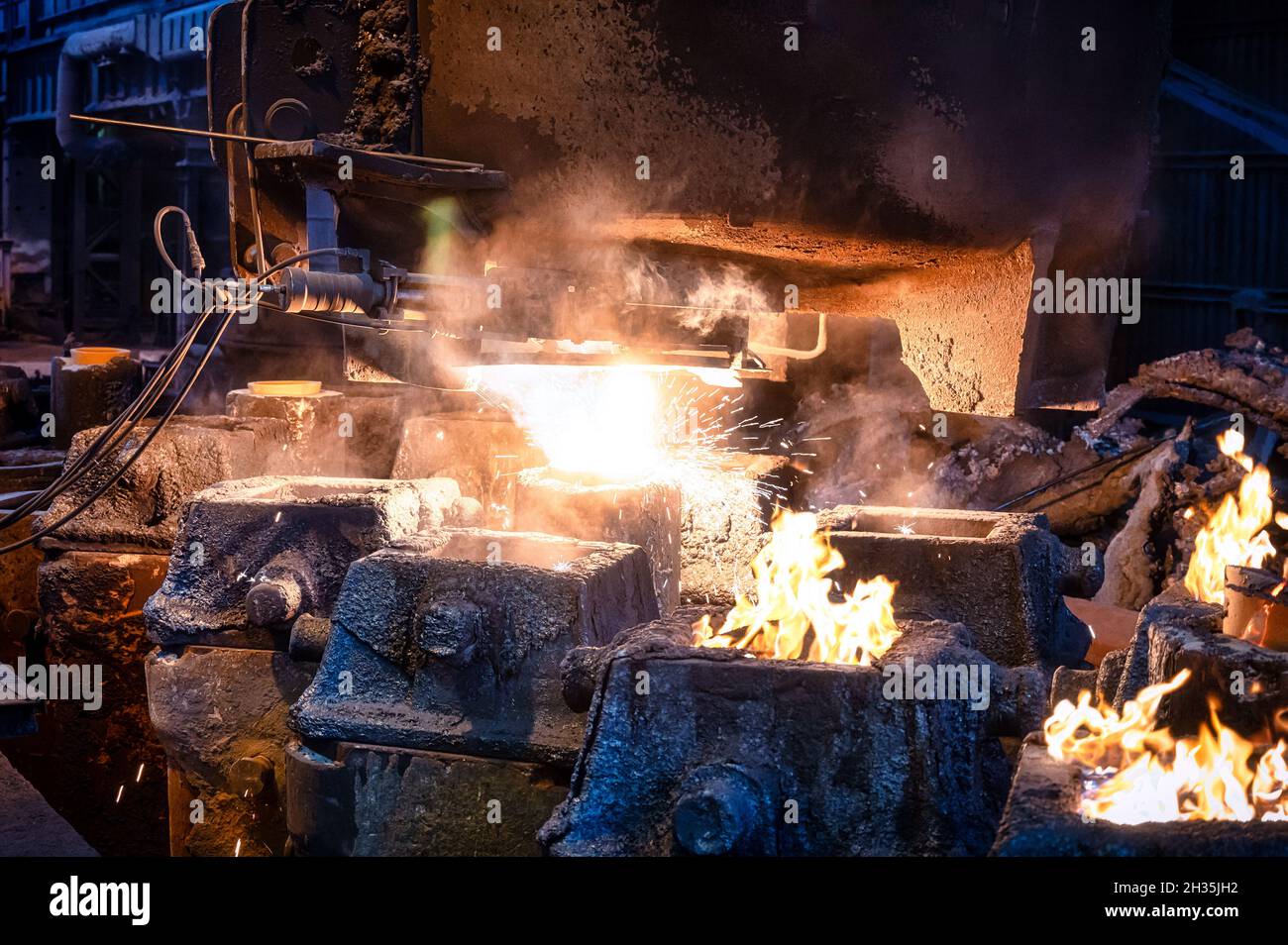 Liquid metal is poured into steel molds from metallurgical ladle Stock ...
