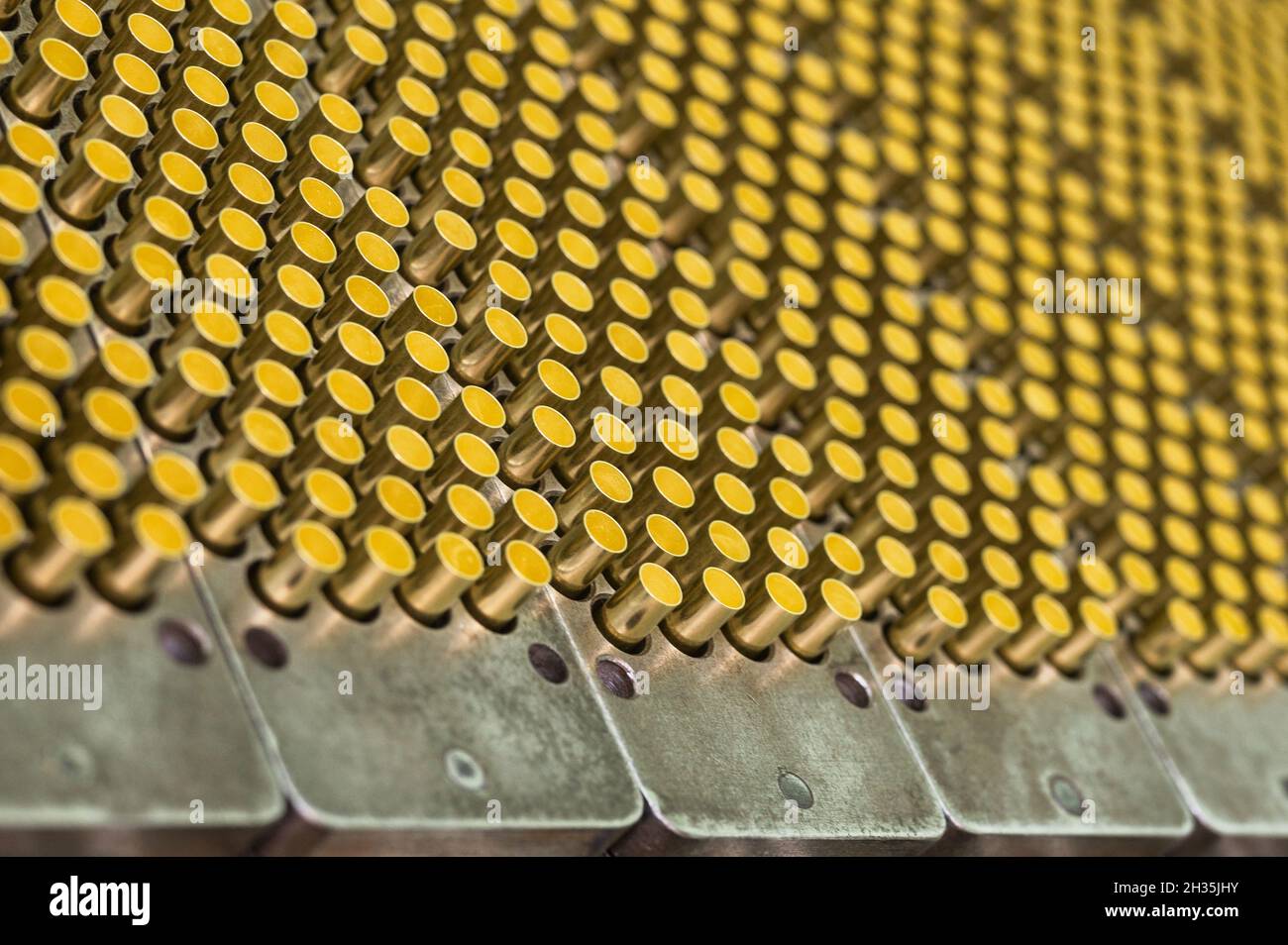 Set of golden bullet shells in metal cartridges on stand Stock Photo ...