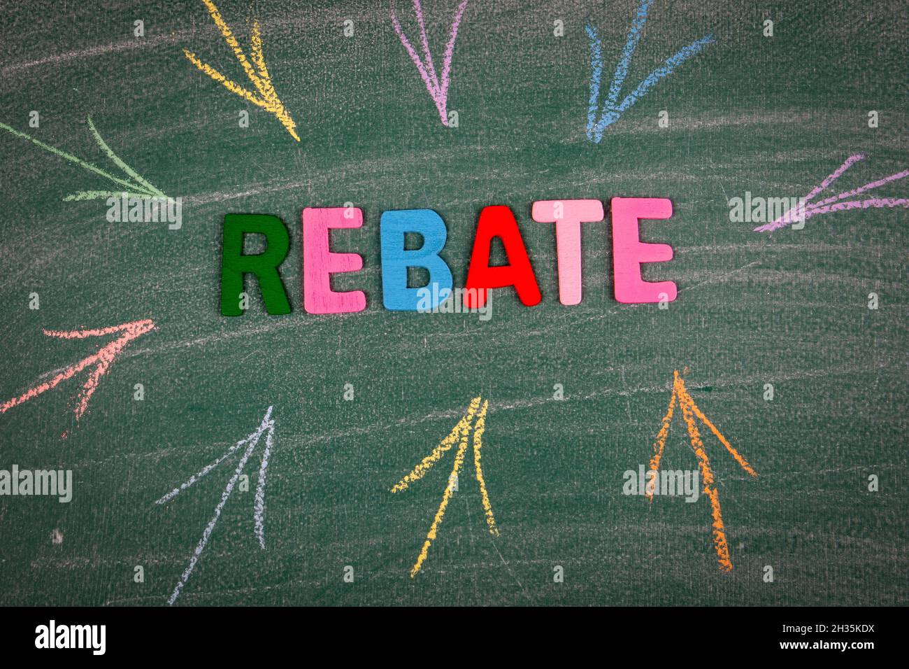 Rebate, business concept. Word and colored arrows on the green board ...