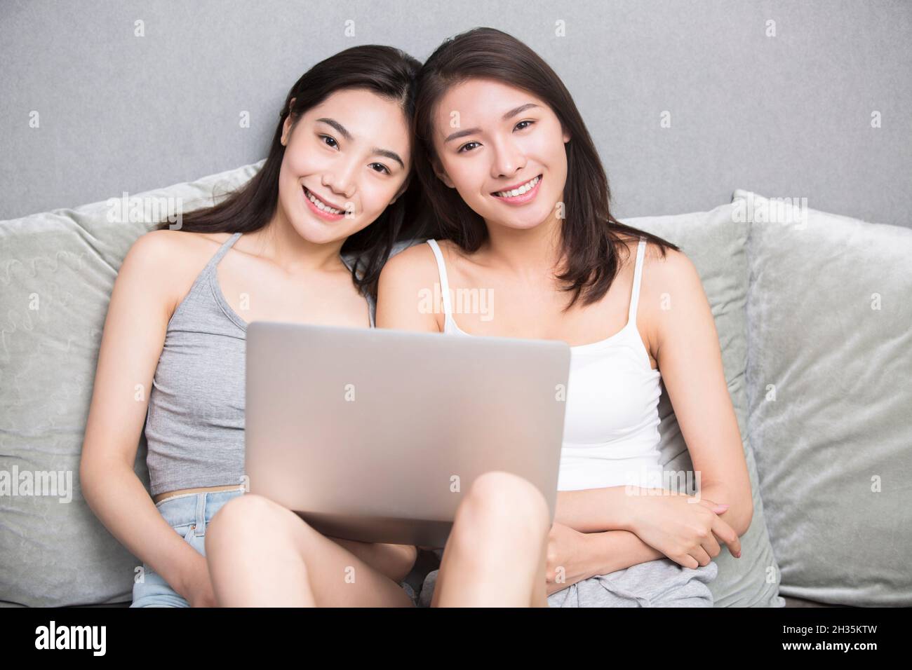 Two best friends using a computer together Stock Photo - Alamy