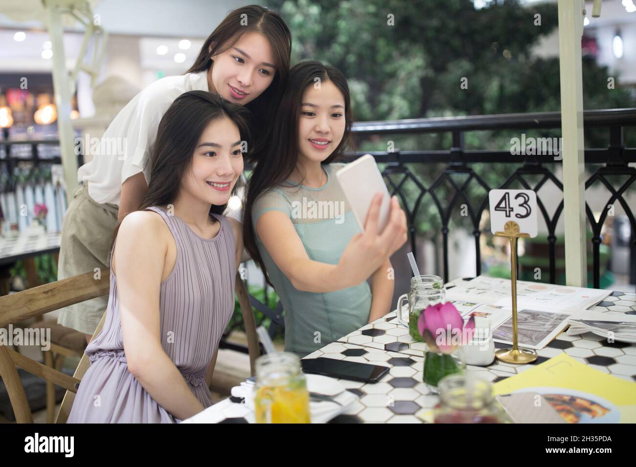 Portrait three friends table hi-res stock photography and images - Alamy