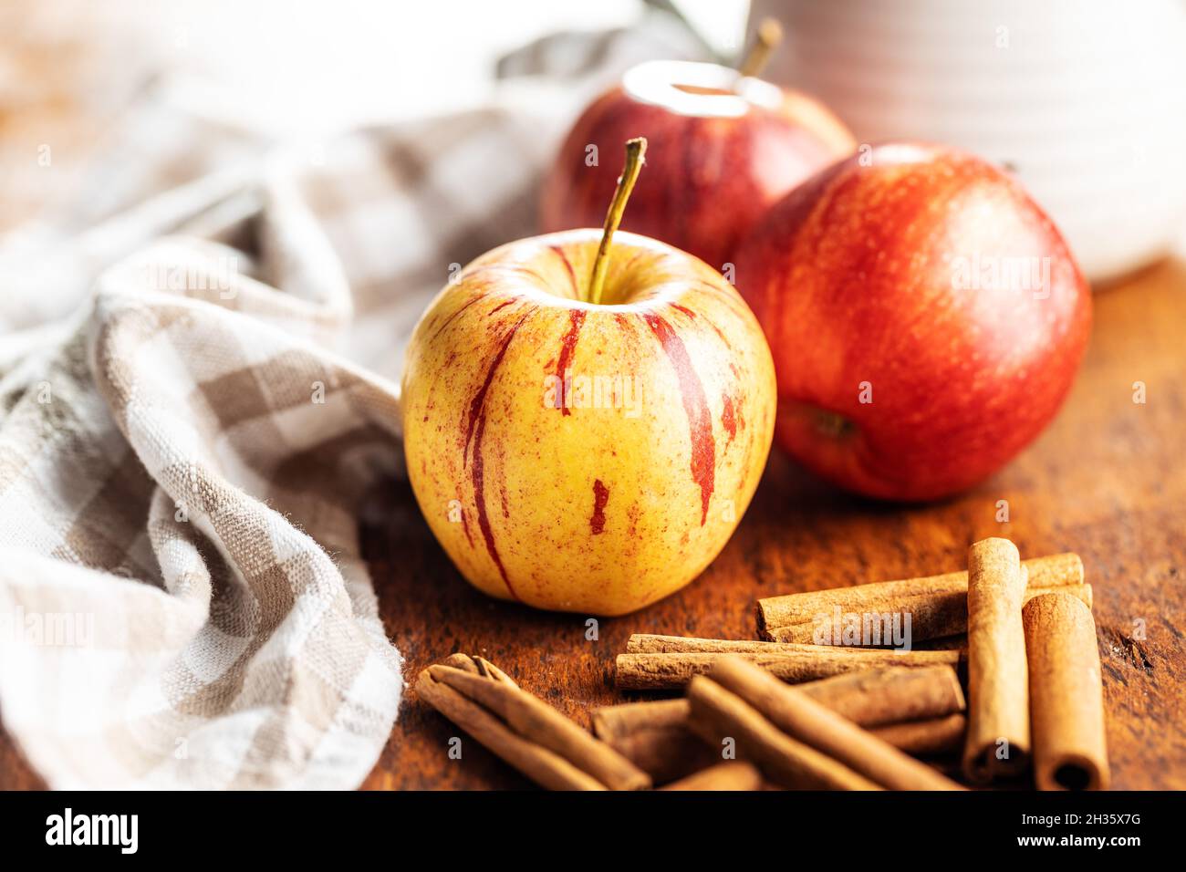 Fresh autumn apples and cinnamon sticks on wooden table Stock Photo - Alamy
