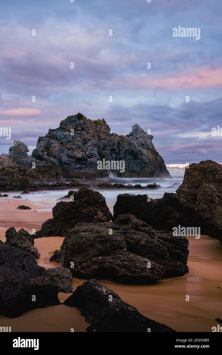 Vertical shot of rocky seashore with beautiful sunset background Stock ...