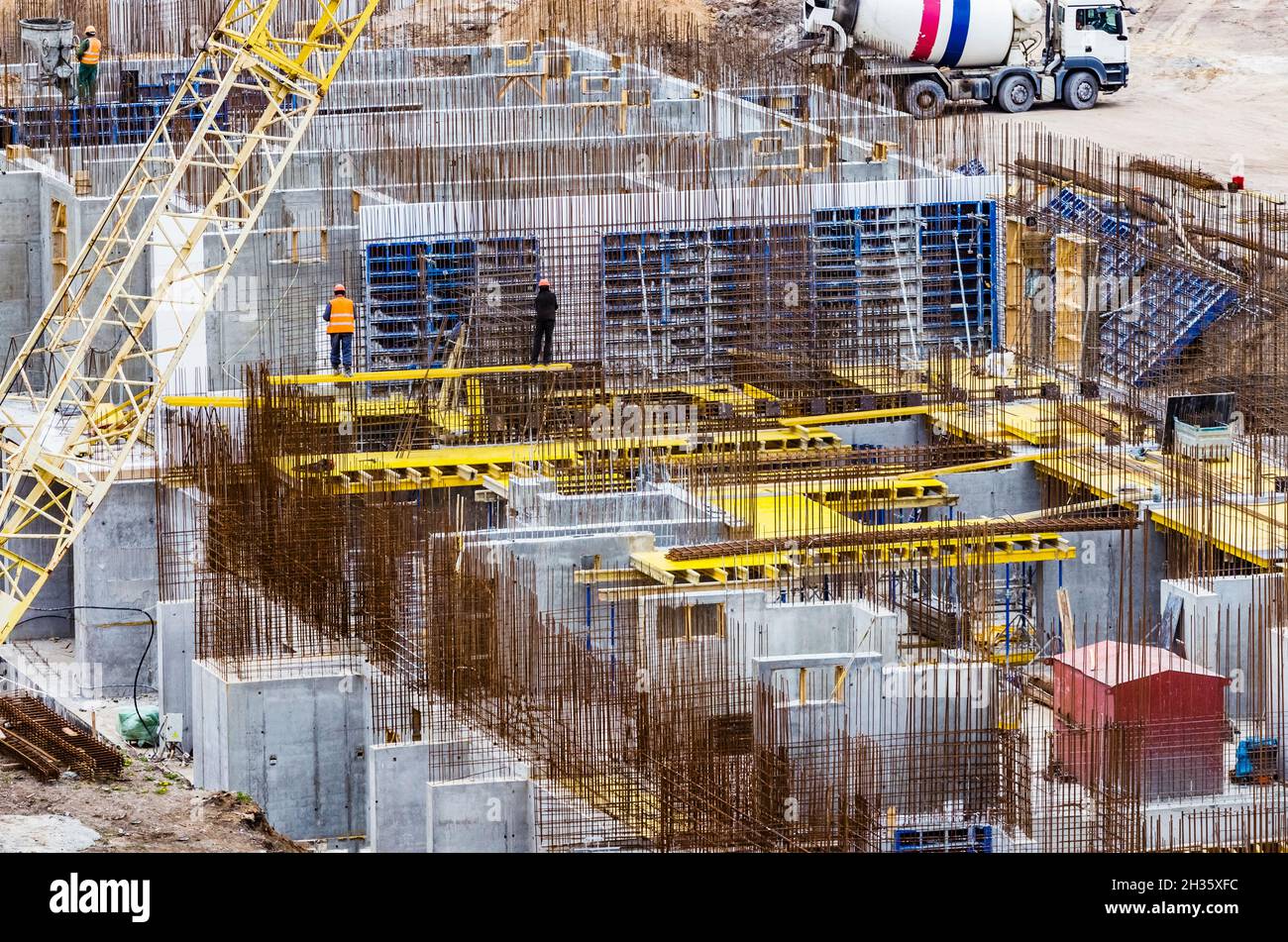 Construction workers install formwork and iron rebars or reinforcing ...