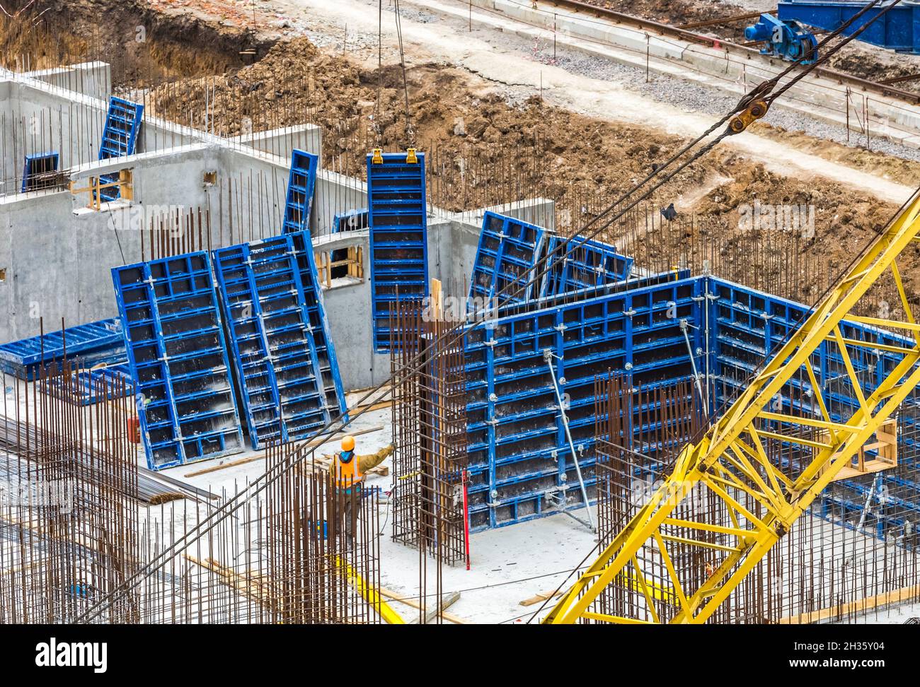 Construction workers install formwork and iron rebars or reinforcing ...