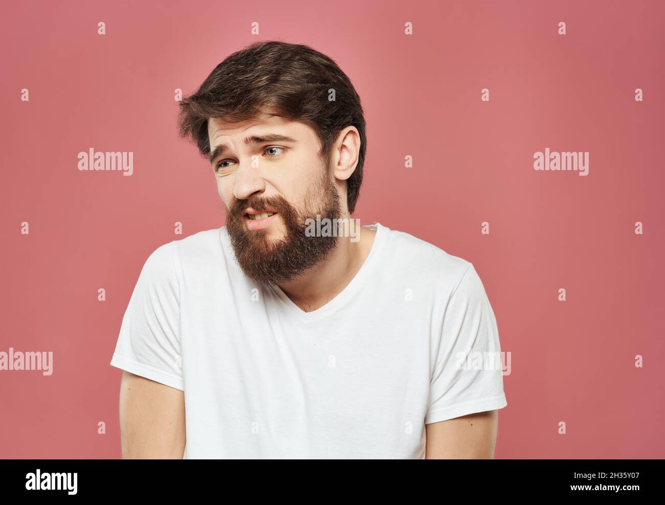 emotional man in a white t-shirt irritated facial expression Studio ...