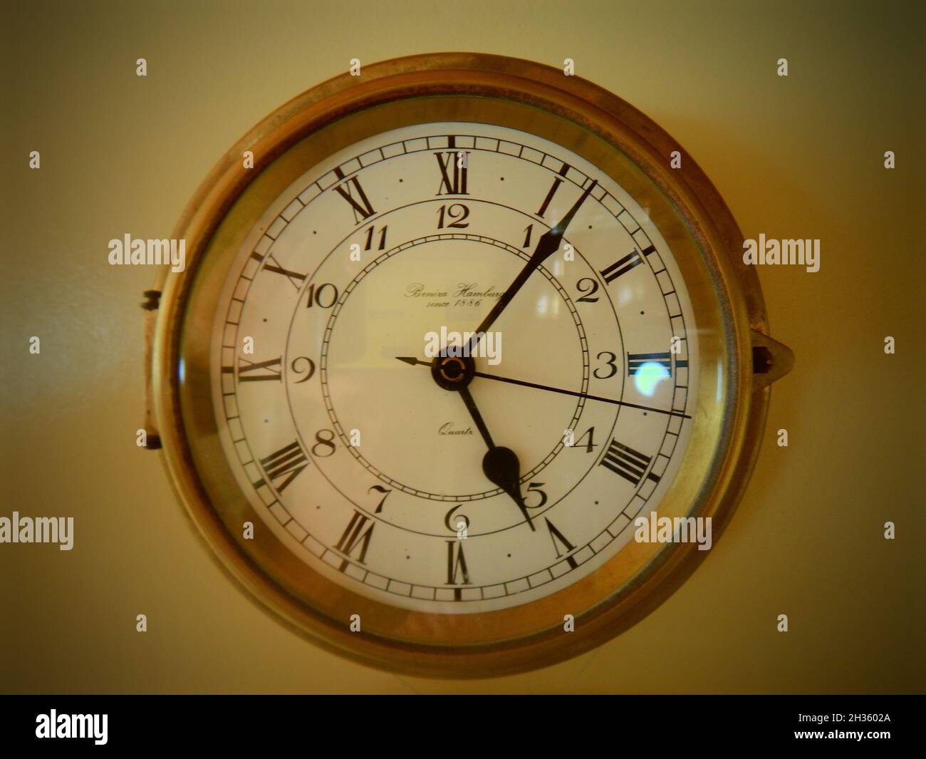 old bronze ship clock in use on sailing ship Stock Photo - Alamy