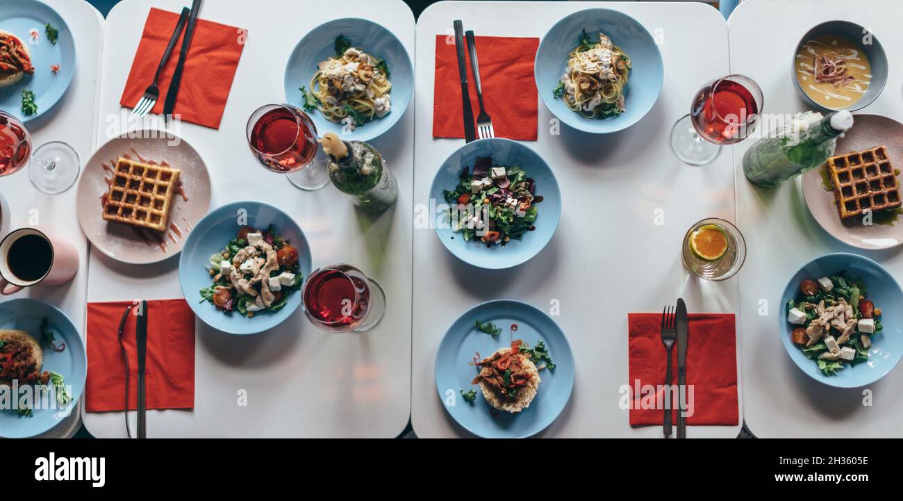 Set table ready meal for a group of people top view Stock Photo - Alamy
